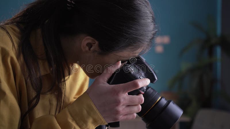 Female Photographer in an Equipped Home Photo Studio is Preparing for ...