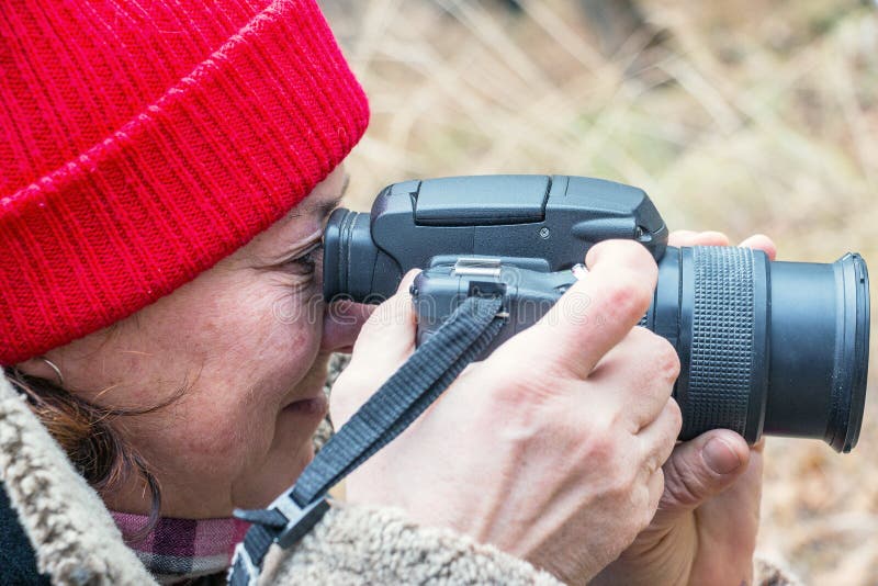 Female Photographer Looking in Viewfinder Stock Image - Image of ...