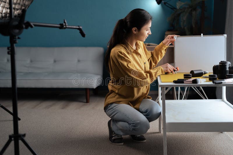 Female Photographer Preparing for the Shooting Laying Out Props on the ...