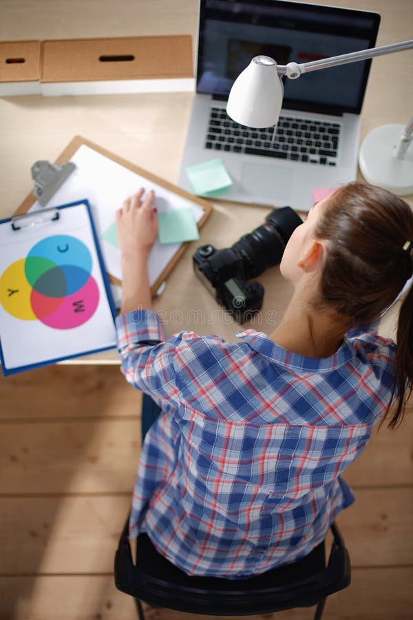 Female Photographer Sitting on the Desk with Stock Photo - Image of ...