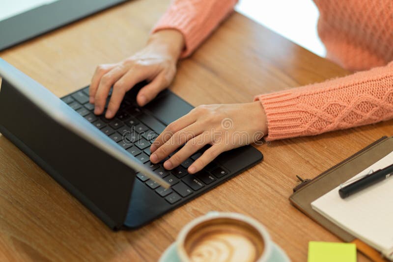 Female in Pink Sweater Typing on Keyboard, Working on Portable Tablet ...