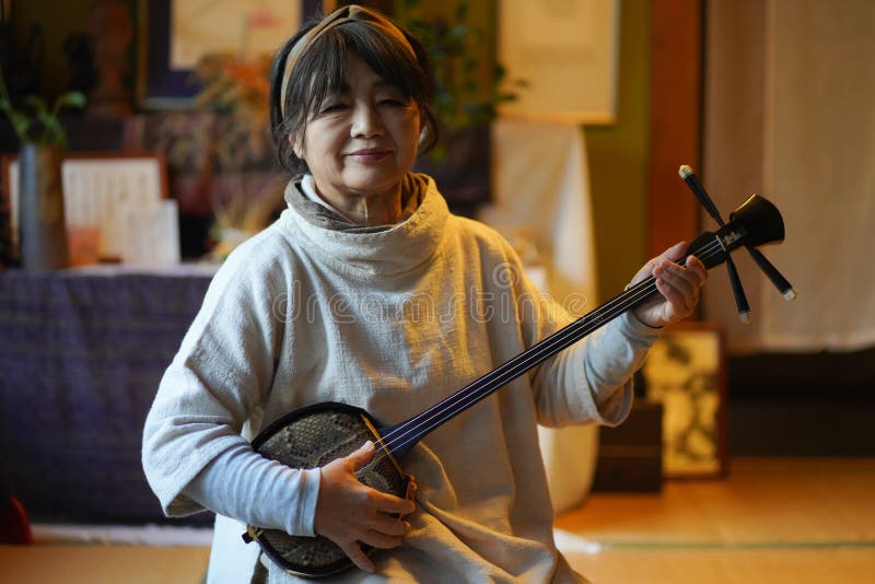 Female playing the sanshin stock image. Image of working - 241187533