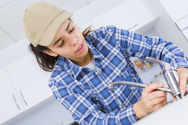Female Plumber Fitting Kitchen Tap Stock Image - Image of people ...