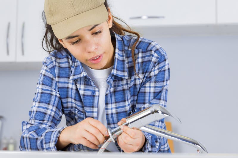 Female Plumber Working on Sink Using Wrench Stock Image - Image of ...