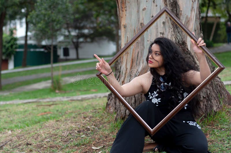Female Poking Head Out of Picture Frame in Park Stock Photo - Image of ...