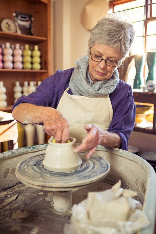 Female potter making pot stock image. Image of concentration - 75202611