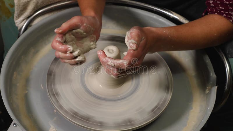 A Female Potter S Hands Sculpt a Piece of Clay Using a Potter S Wheel ...