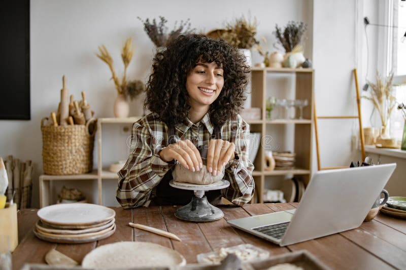 Woman Shaping Pottery while Using Laptop in Studio Stock Image - Image ...