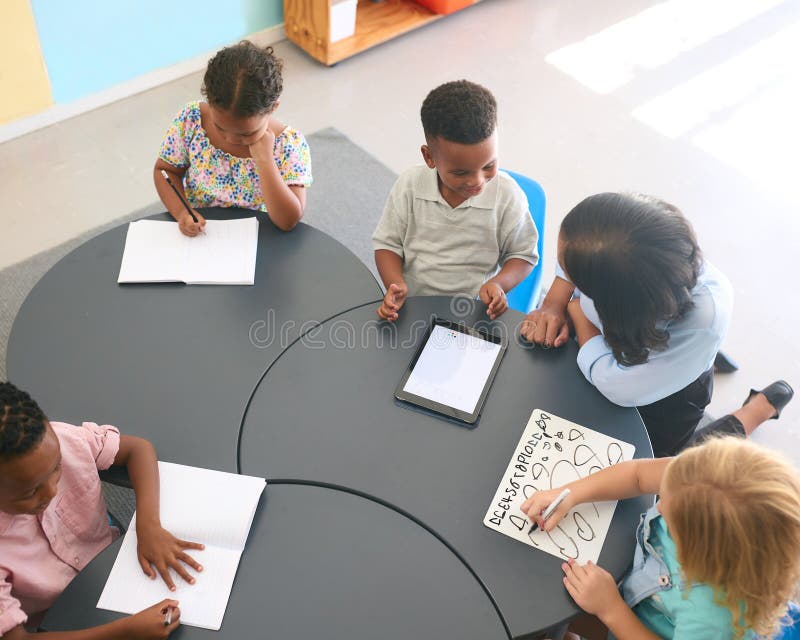 Line of Smiling Primary or Elementary School Students Sitting on Floor ...