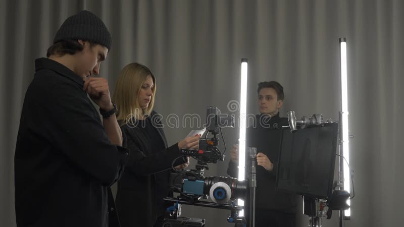 Female Producer, Camera Operator and Lighting Technician in the Studio ...