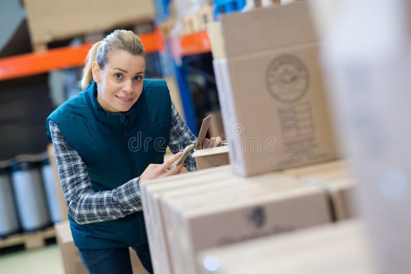 Female Professional Courier with Boxes Delivering Packages at ...