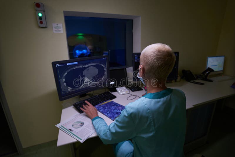 Doctor Using Computer during MRI of Male Patient Stock Photo - Image of ...