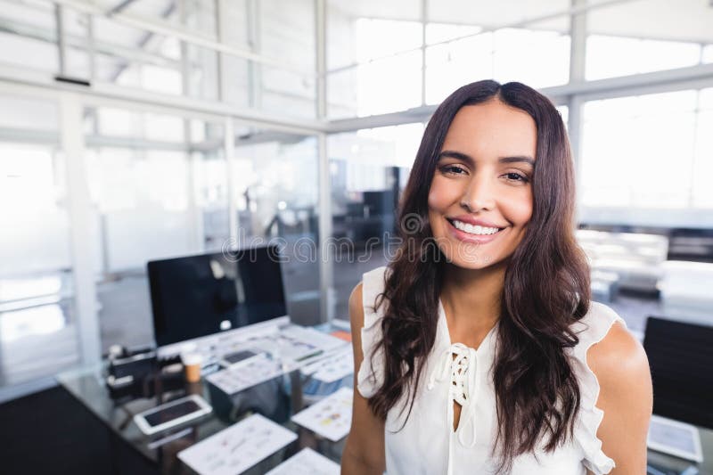 Female Professional Standing beside Desk in Open-plan Office Smiling ...