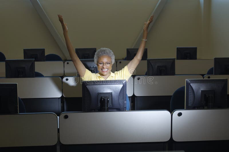 Female Professor Celebrating Victory in Computer Classroom Stock Photo ...