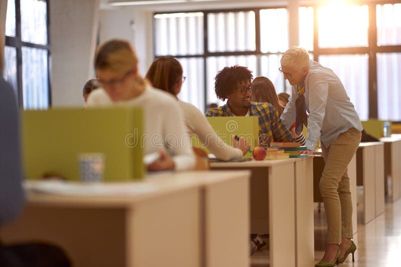 Female Professor Checking Student Work at a Lecture Stock Photo - Image ...