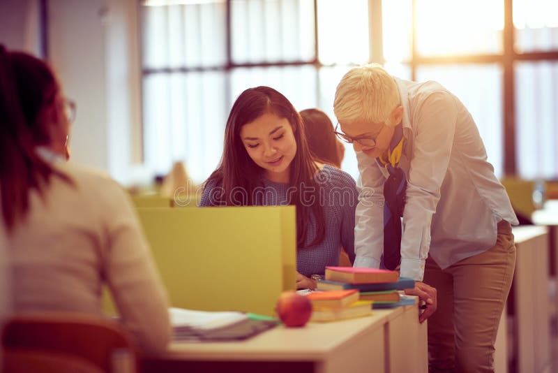 Professor Helping a Student in Classroom Stock Photo - Image of ...