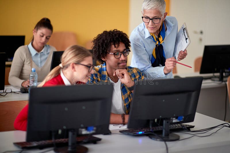 Female Professor Helping Students at an Informatics Lecture Stock Image ...