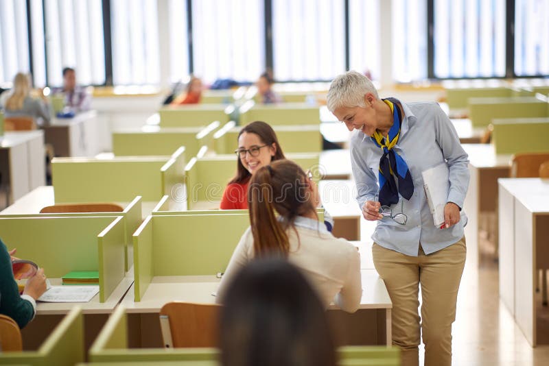 Female Professor at a Lecture Checking Student`s Work Stock Image ...