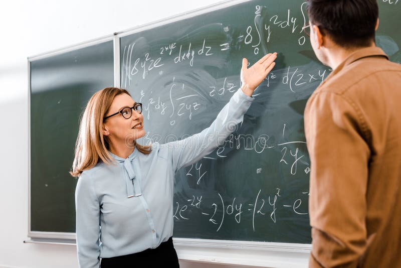 Female Professor Showing Equations Stock Image - Image of caucasian ...