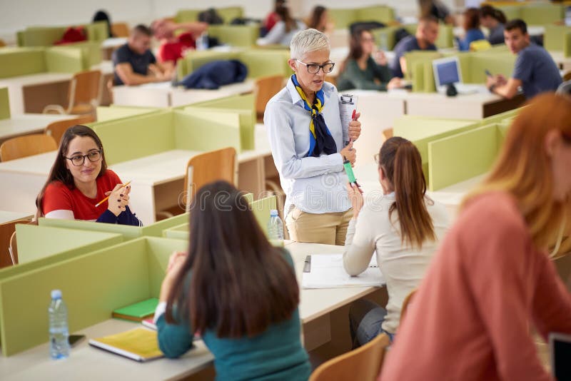 Female Professor with Students at a Lecture. Smart Young People Study ...