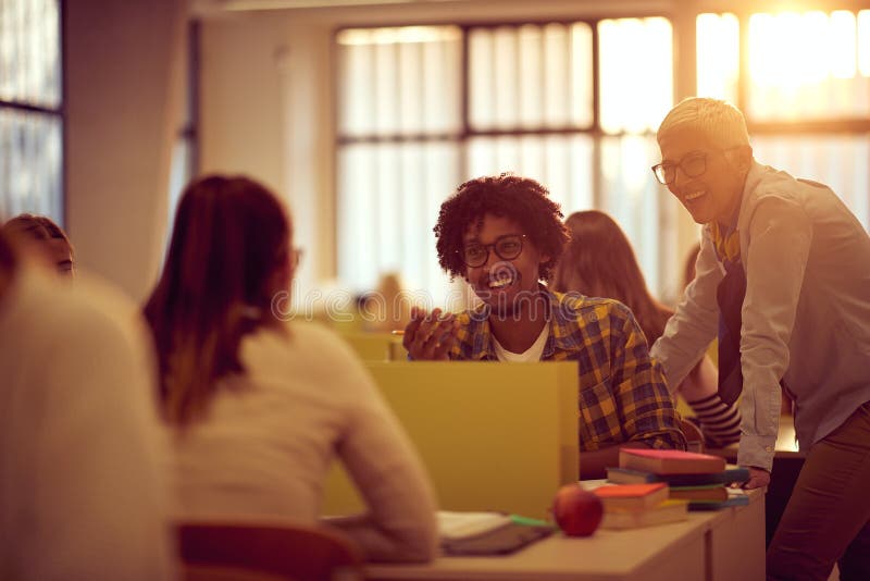 Female Professor and Students in Relaxed Conversation about the Lesson ...