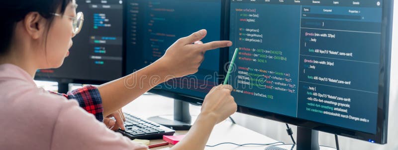Female Programer Explain While Pointing Code Displayed On Computer