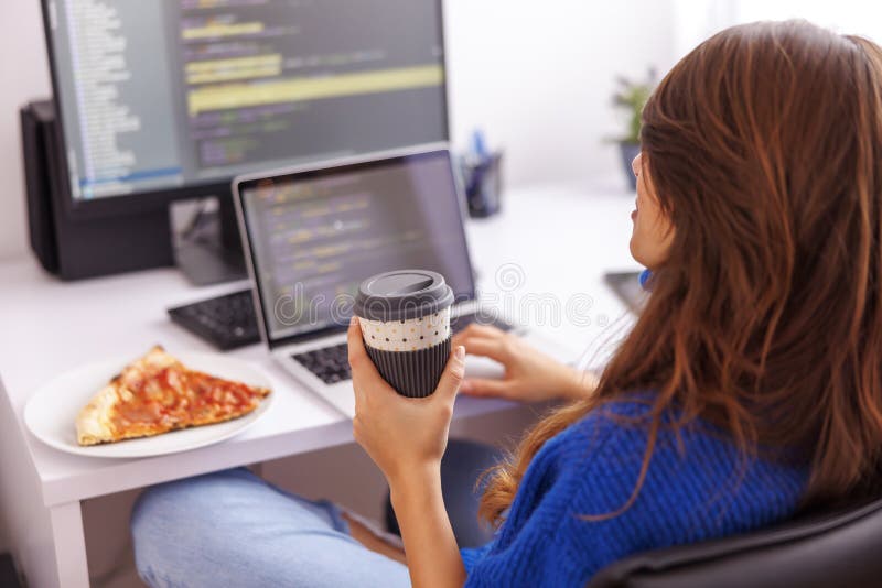 Female Programmer Drinking Coffee and Eating Pizza while Working ...