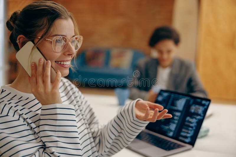 Female Programmer is Talking Phone while Working on Laptop and Drinking ...