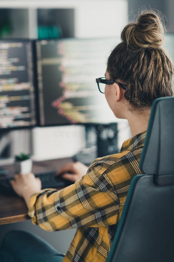 Female Programmer Working on Coding Project at Desk in Cozy Modern Workspace with Multiple ...