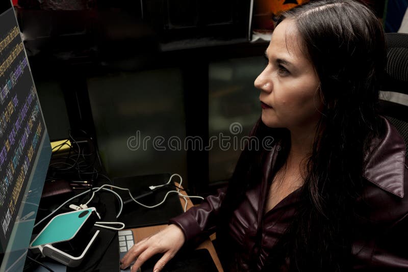 Female Programmer Working In Front Of Computer Sitting At Desk Works And Writes Codes And