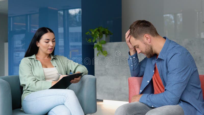 Female Psychologist Making Note While Patient Talking Stock Video