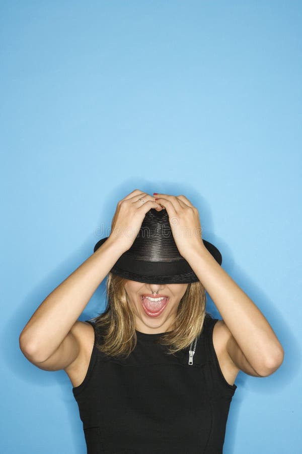 Female pulling hat down stock photo. Image of color, women - 2051452