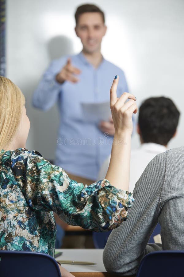 Female Pupil Answering Question in Class Stock Photo - Image of ...
