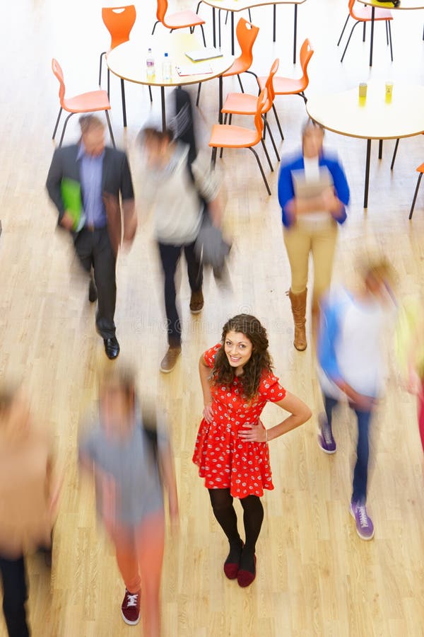 Female Pupil in Classroom Surrounded by Moving Students Stock Image ...