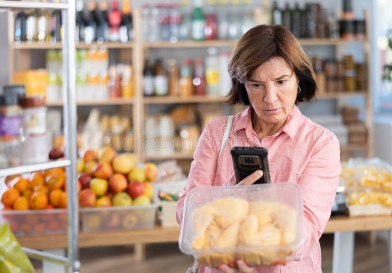 Female Purchaser Scanning QR Code or Barcode of Chicken Thighs in Shop ...