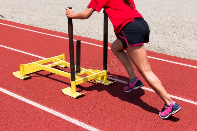 Female Pushes a Yellow Sled on a Track at Practice Stock Photo - Image ...