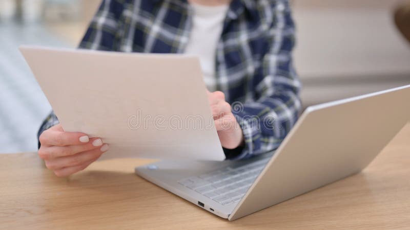 Female Reading Documents while Using Laptop, Close Up Stock Photo ...