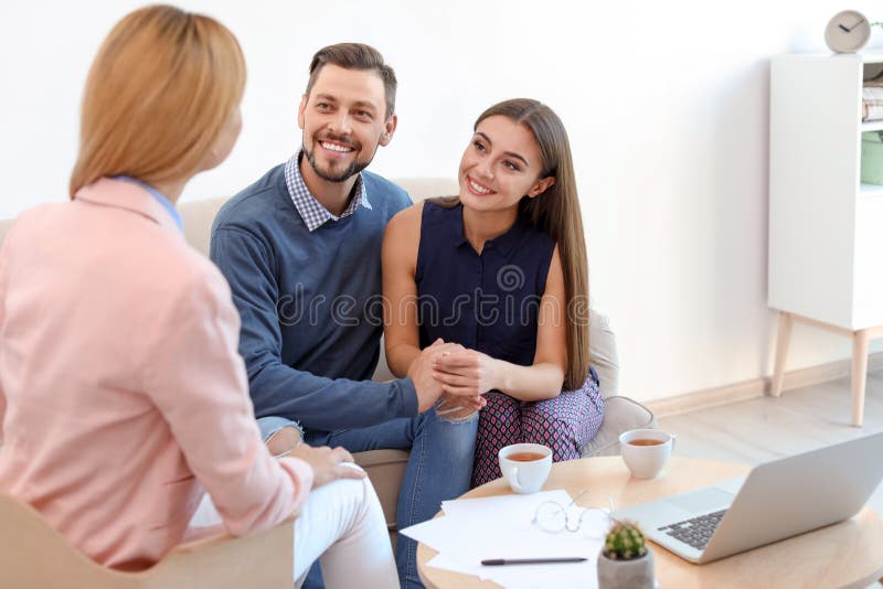 Female Real Estate Agent Working with Couple Stock Image - Image of ...