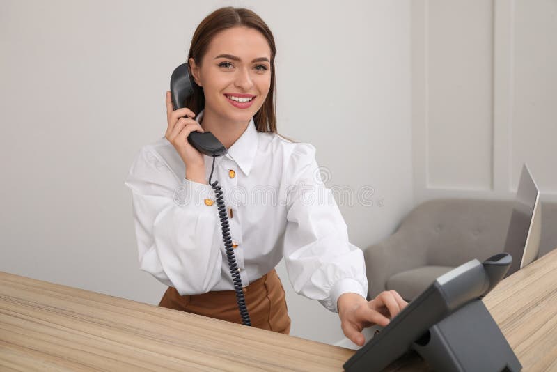 Female Receptionist Talking on Phone at Workplace Stock Image - Image ...