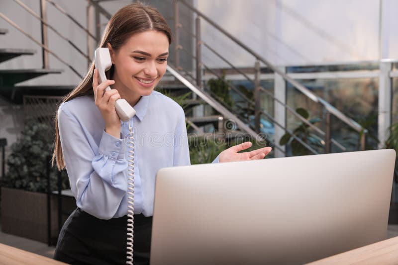 Female Receptionist Talking on Phone at Workplace Stock Photo - Image ...