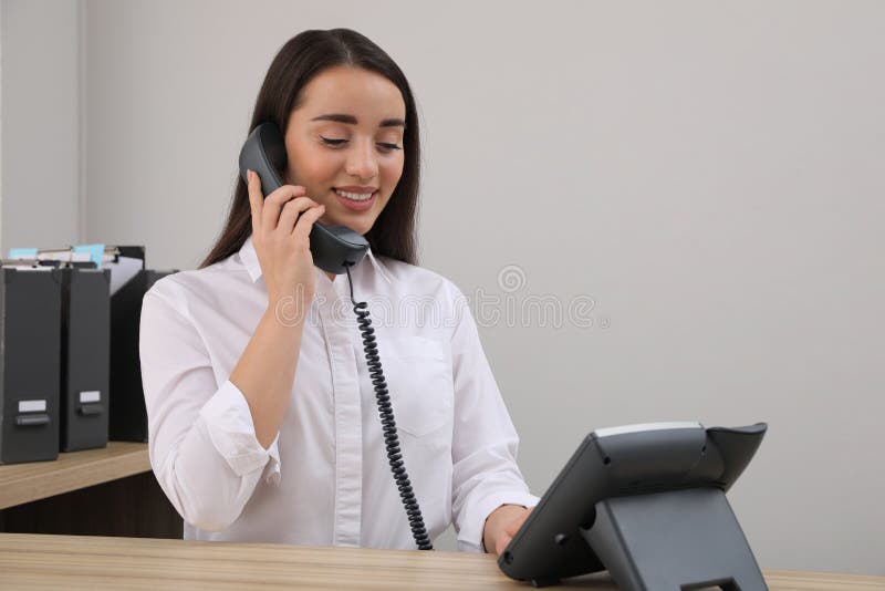 Female Receptionist Talking on Phone at Workplace Stock Photo - Image ...