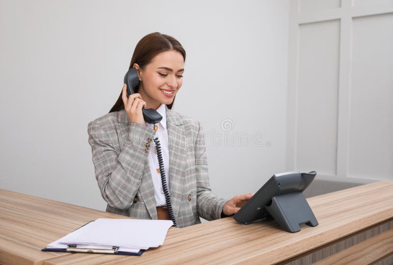 Female Receptionist Talking on Phone at Workplace Stock Image - Image ...