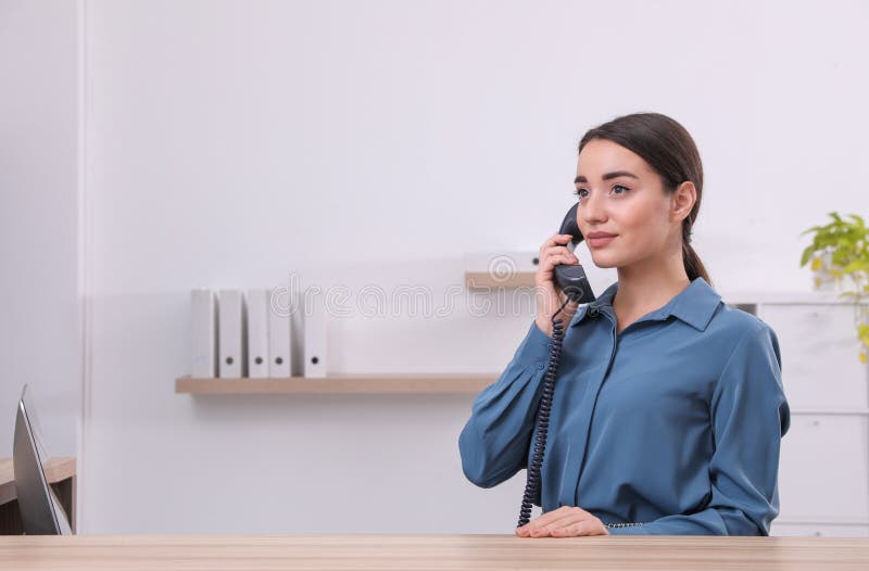 Female Receptionist Talking on Phone at Workplace. Space for Text Stock ...