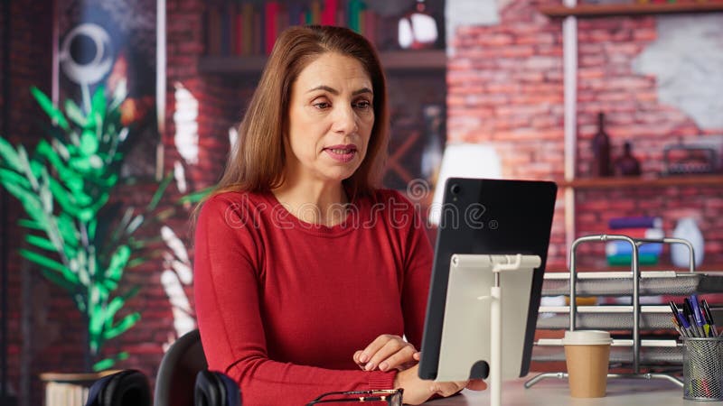 Female Remote Worker Smiling during a Virtual Meeting with Her Trainer ...