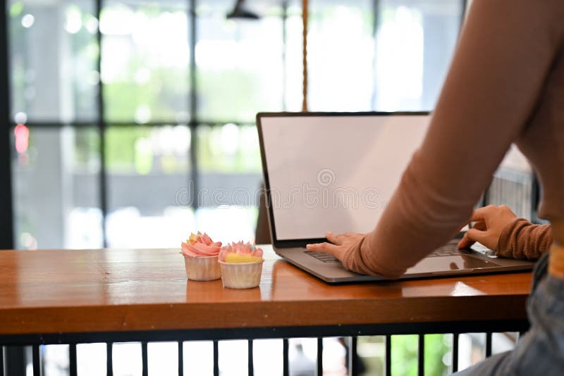 A Female Remote Working in the Coffee Shop, Using a Portable Digital ...