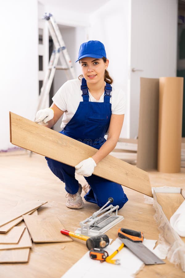 Female Repairer Installing Laminate Flooring Stock Photo - Image of ...