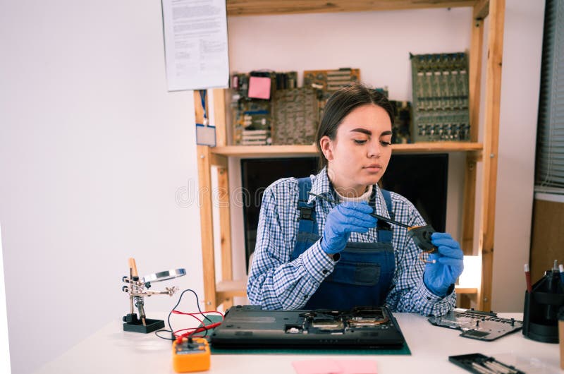 Female Repairman Working in Technical Support Fixing Computer Laptop ...
