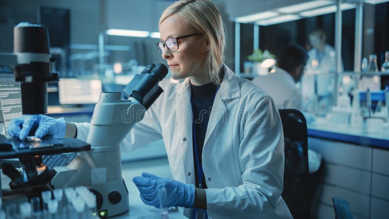 Female Research Scientist is Wearing Glasses and Using Modern ...