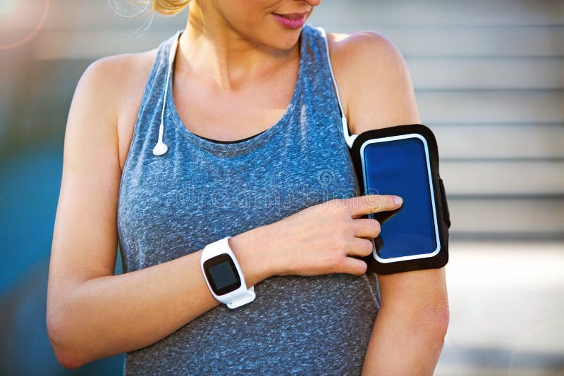 Female Runner with Mobile Phone and Smart Watch Stock Image - Image of ...