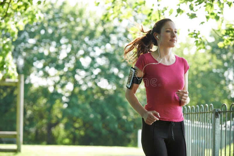 Female Runner in Park with Wearable Technology Stock Image - Image of ...